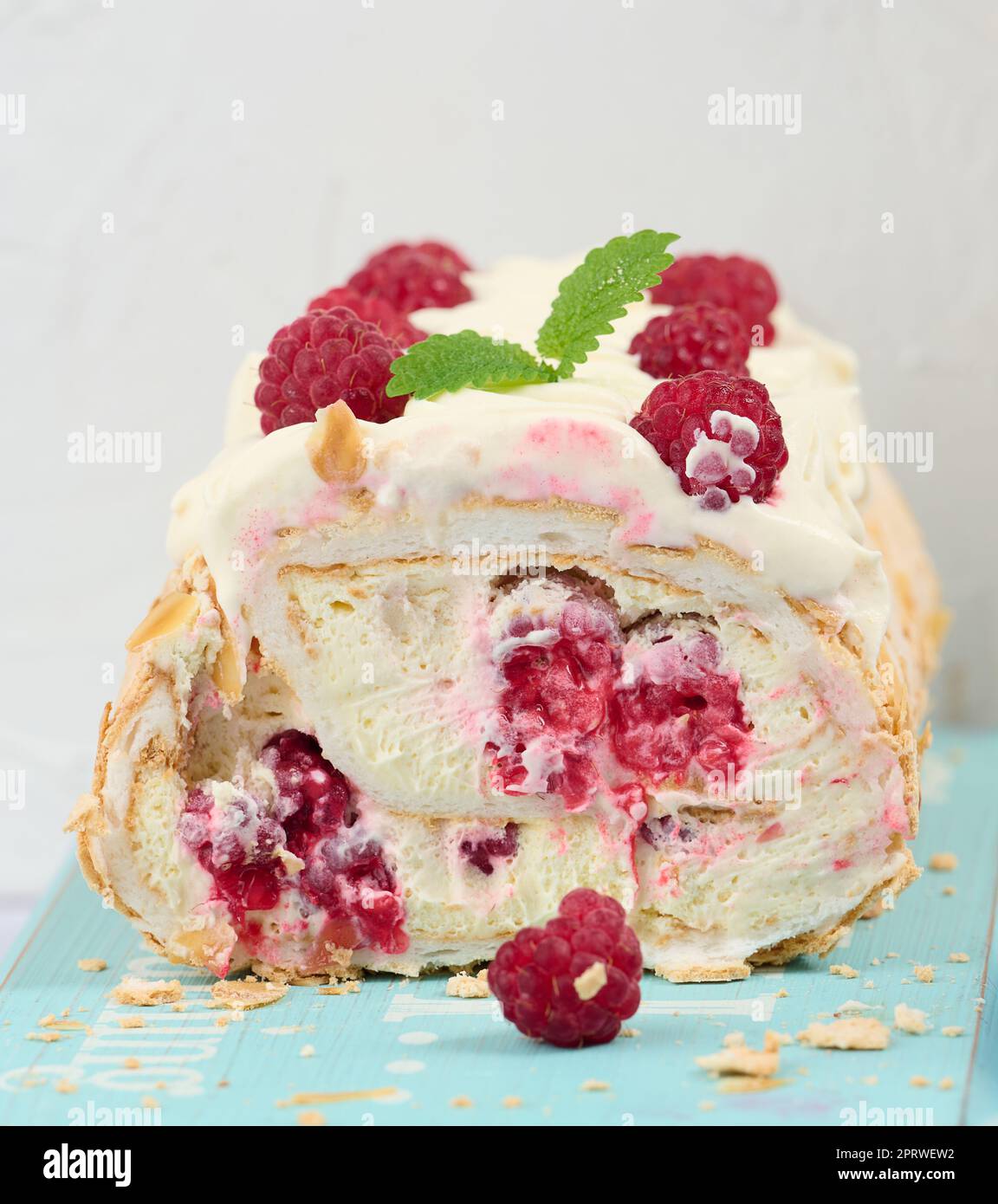 Baked meringue roll with cream and fresh red raspberry, white ...