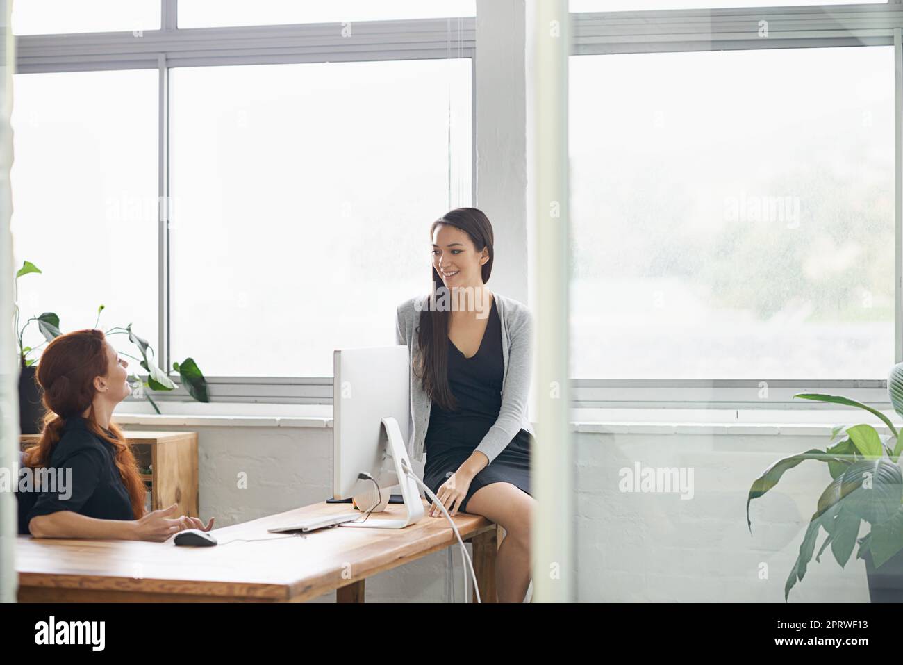 Quick catch up between colleagues. two businesswomen having a friendly ...