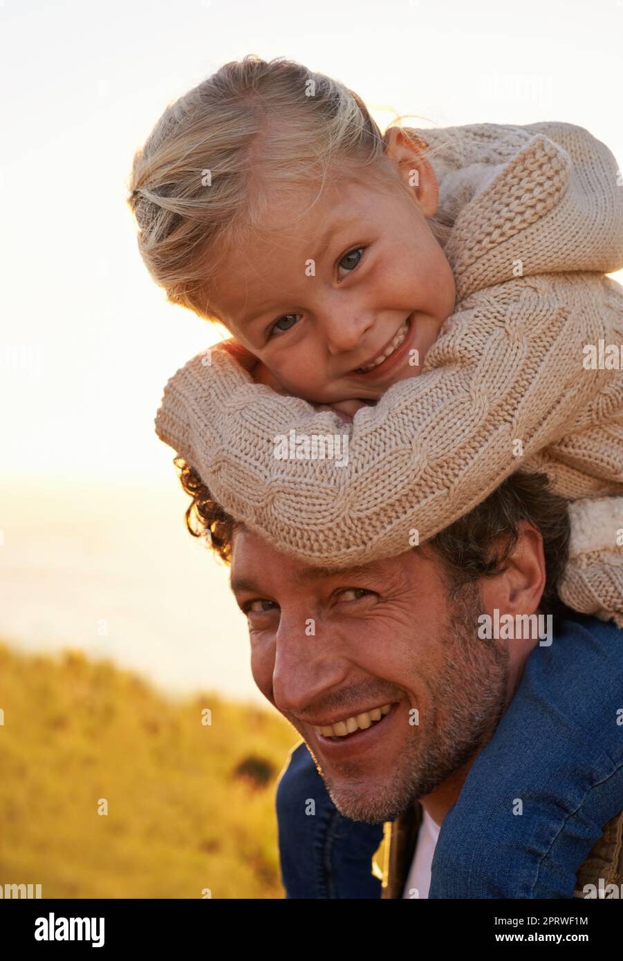 A ride for his princess. Portrait of a father giving his young daughter a ride on his shoulders ...