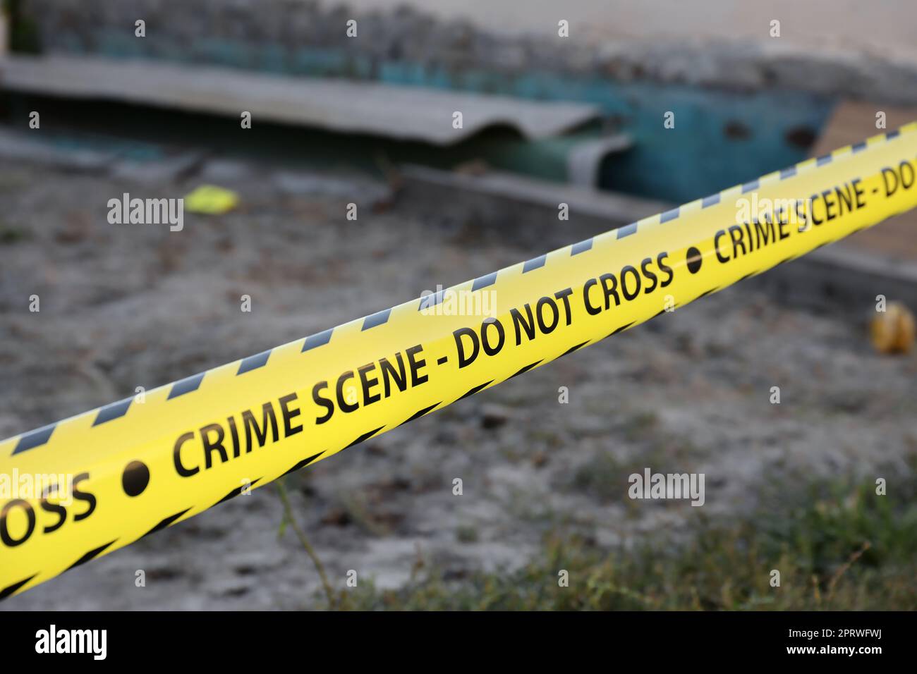 Crime scene tape for covering the area cordon. Yellow tape with blurred ...