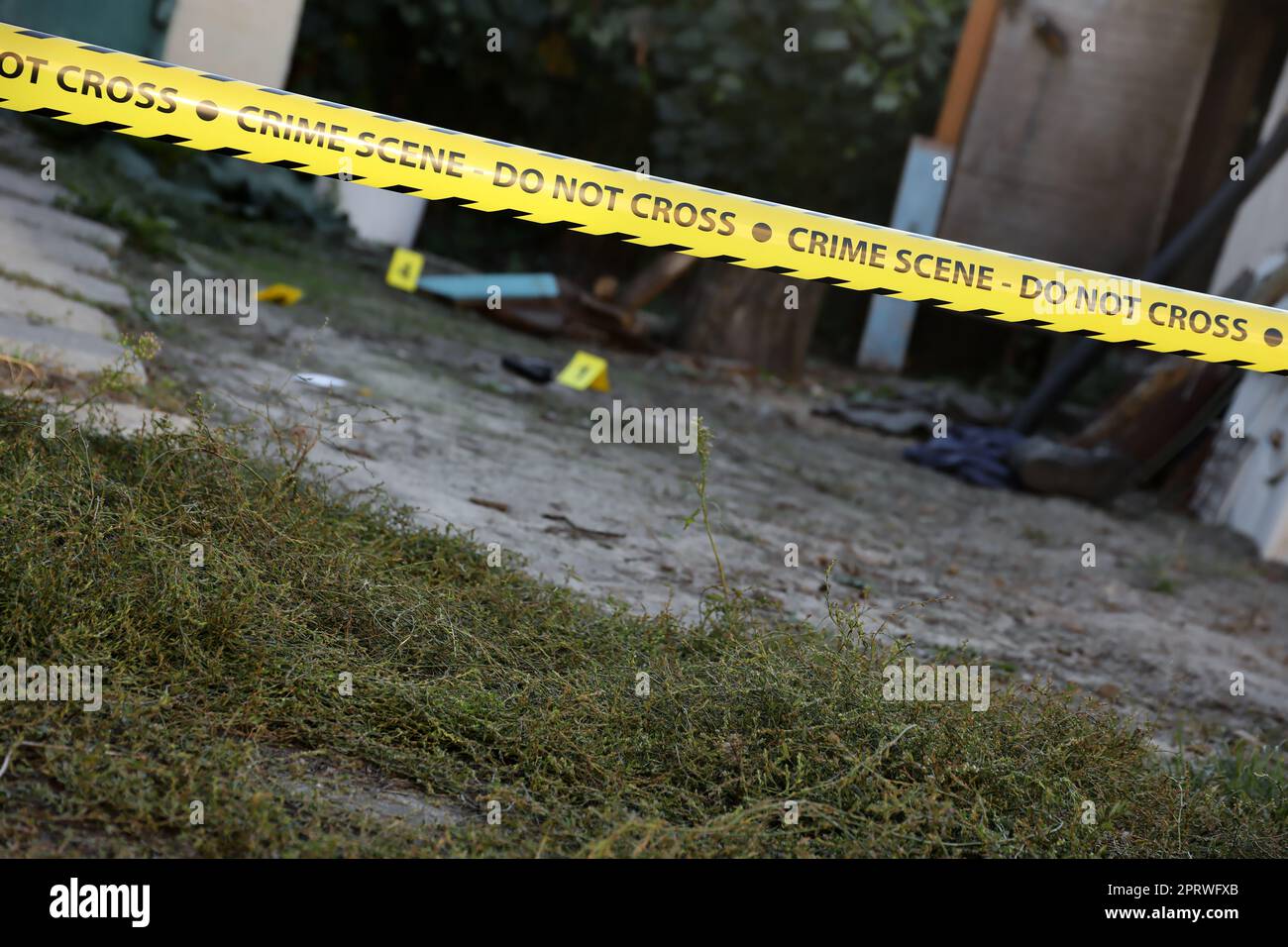 Victim of a violent crime in a backyard of residental house in evening ...