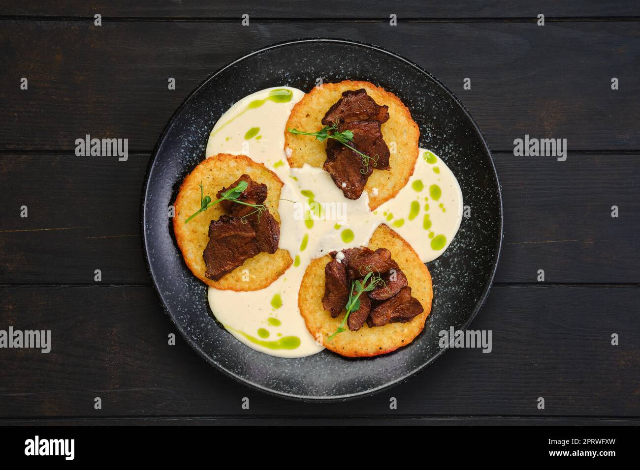 Overhead view of potato fritters with with fried beef Stock Photo - Alamy