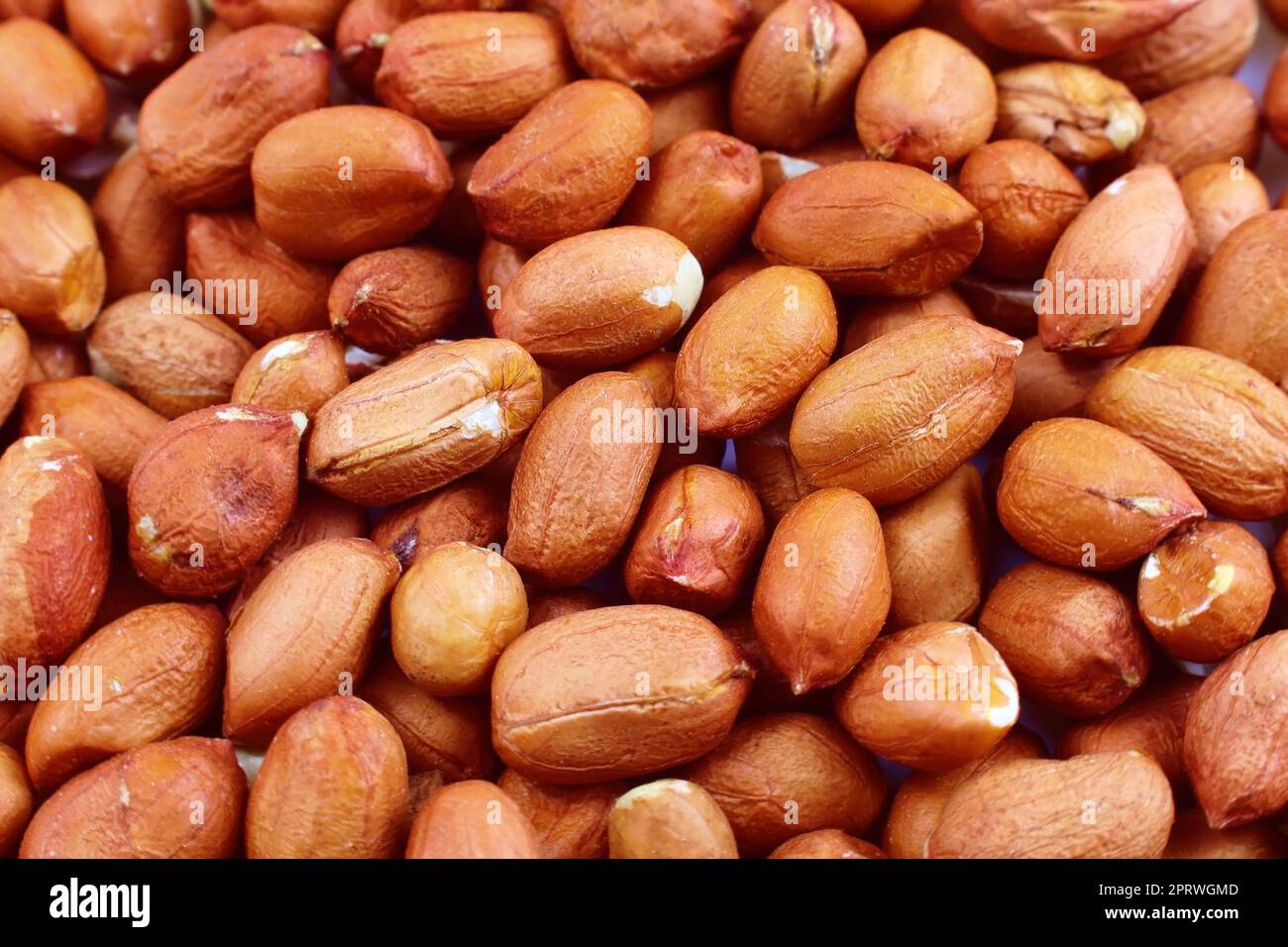 Raw unpeeled peanut nuts texture close up Stock Photo - Alamy