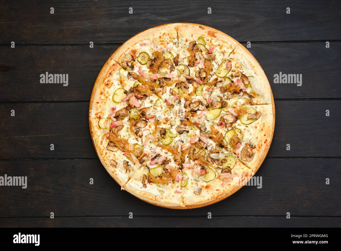 Pizza with bacon, ham, champignon, pickled cucumber and onion Stock ...