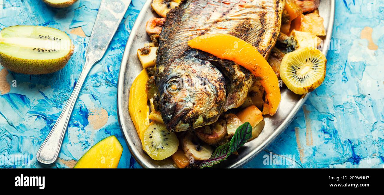 Baked grilled fish in fruit Stock Photo - Alamy