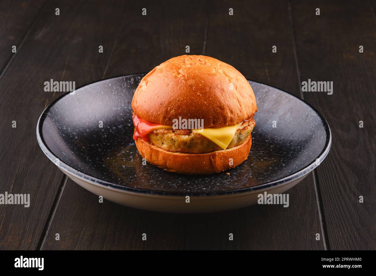 Simple fish burger on wooden board Stock Photo - Alamy