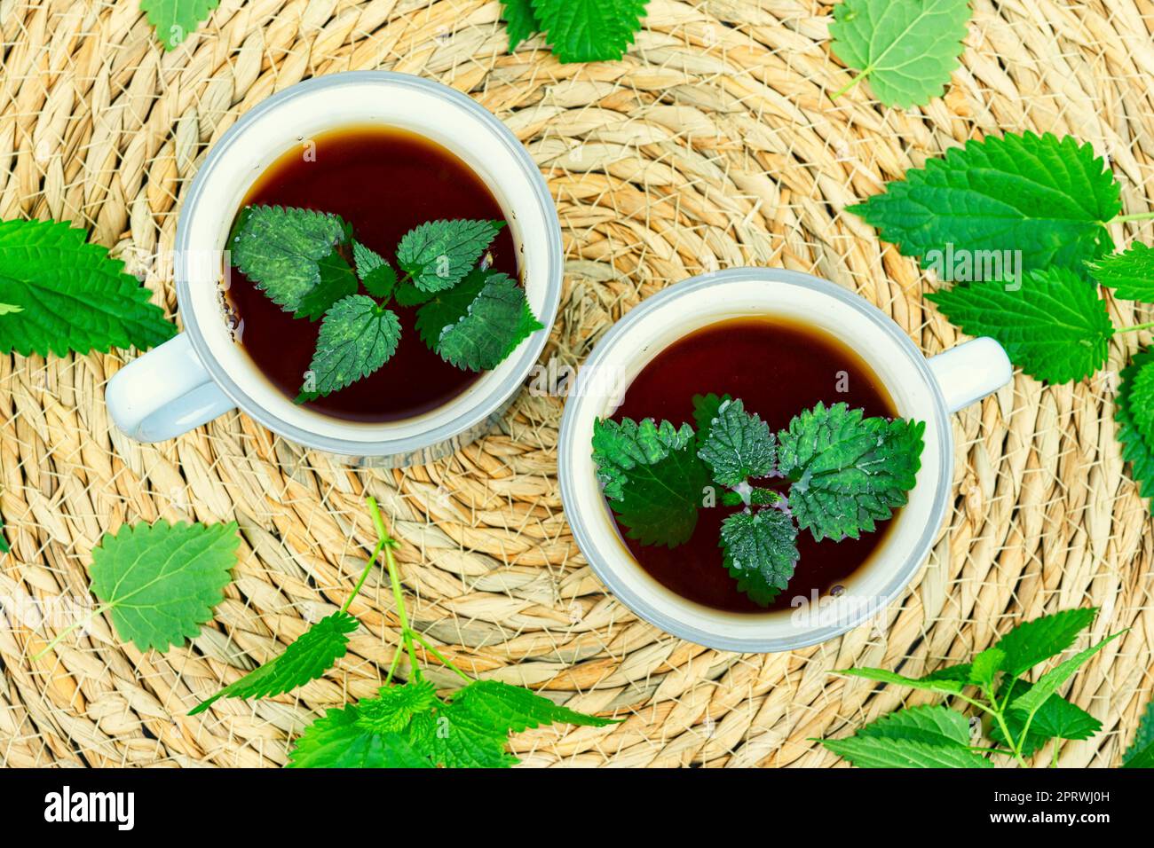 Teacup with herbal tea, healing tea with fresh nettle. Homeopathy ...