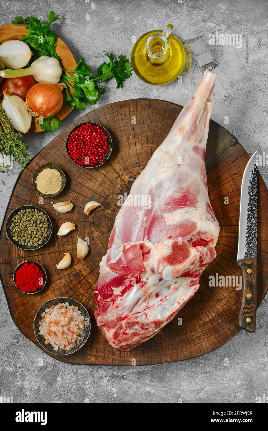 Raw whole lamb leg chump on with ingredients, top view Stock Photo - Alamy