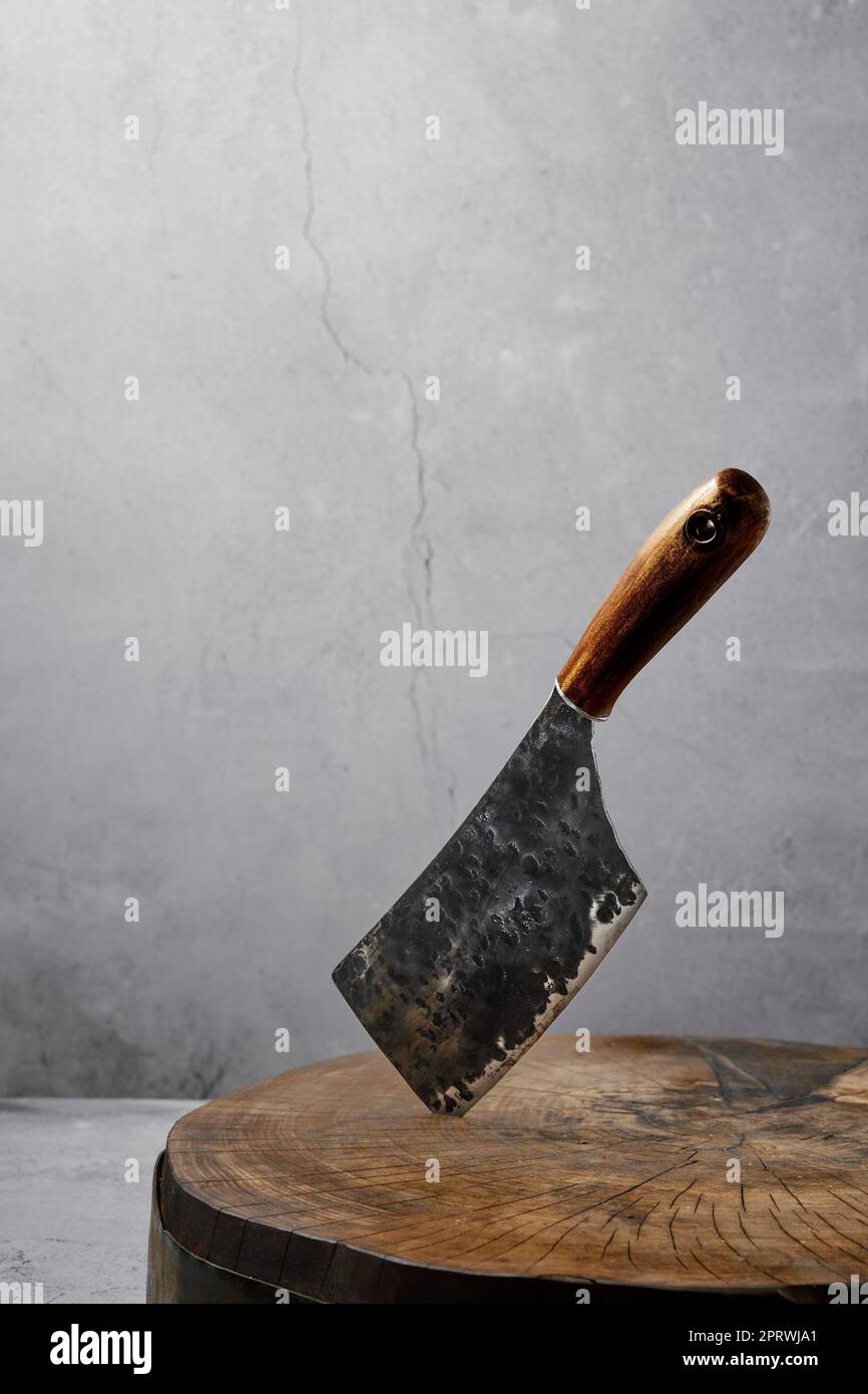 Old butcher's cleaver in wooden log Stock Photo - Alamy