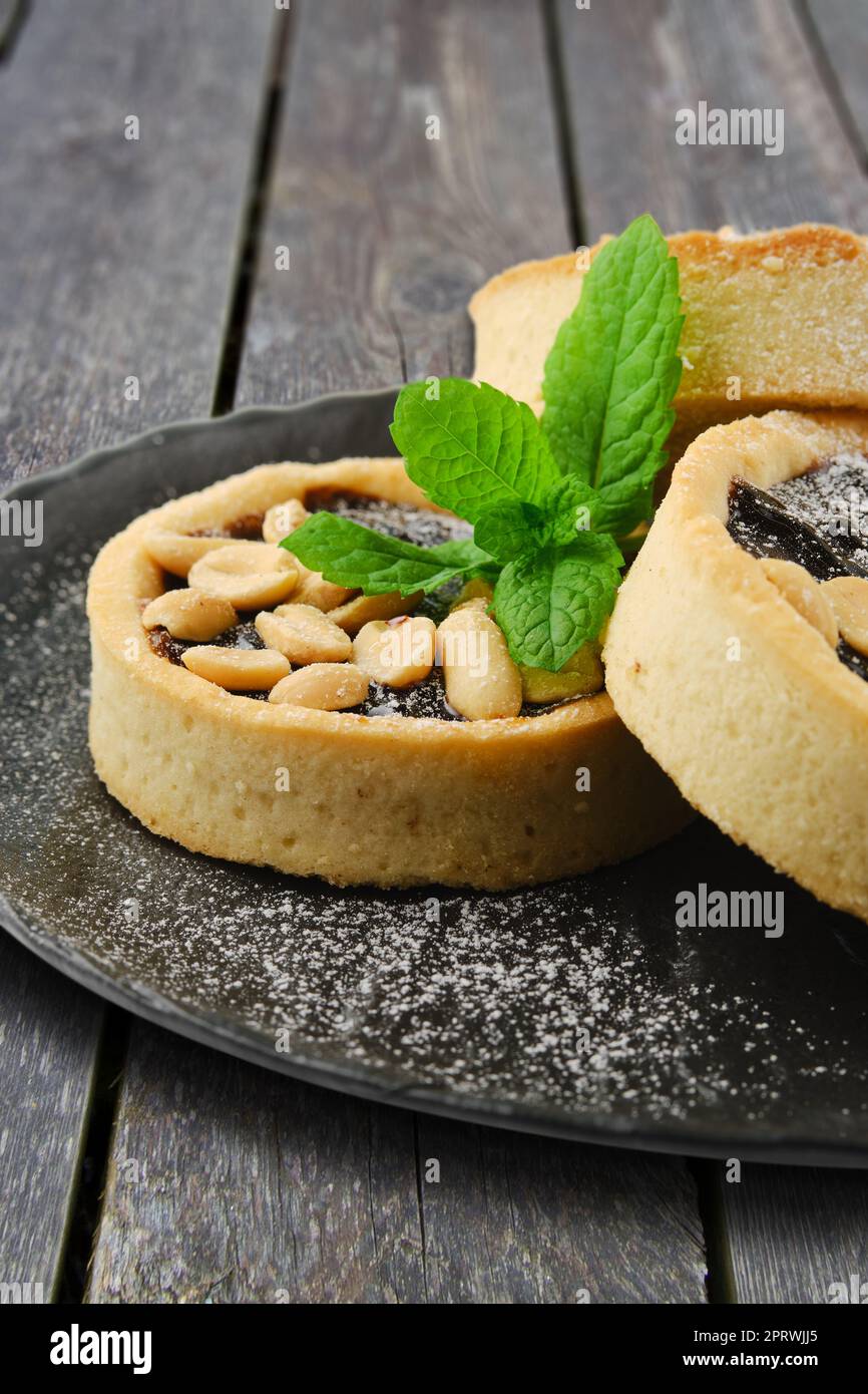Caramel tart with peanut and mint Stock Photo - Alamy