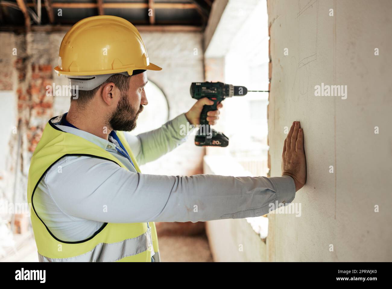 Construction worker, man or drilling wall with electric tool for ...