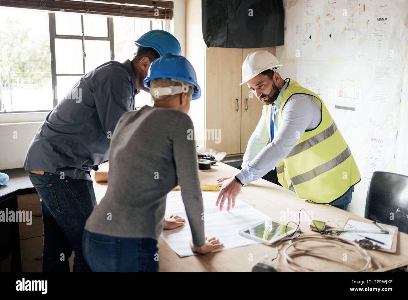 Construction workers, teamwork collaboration and blueprint planning in ...