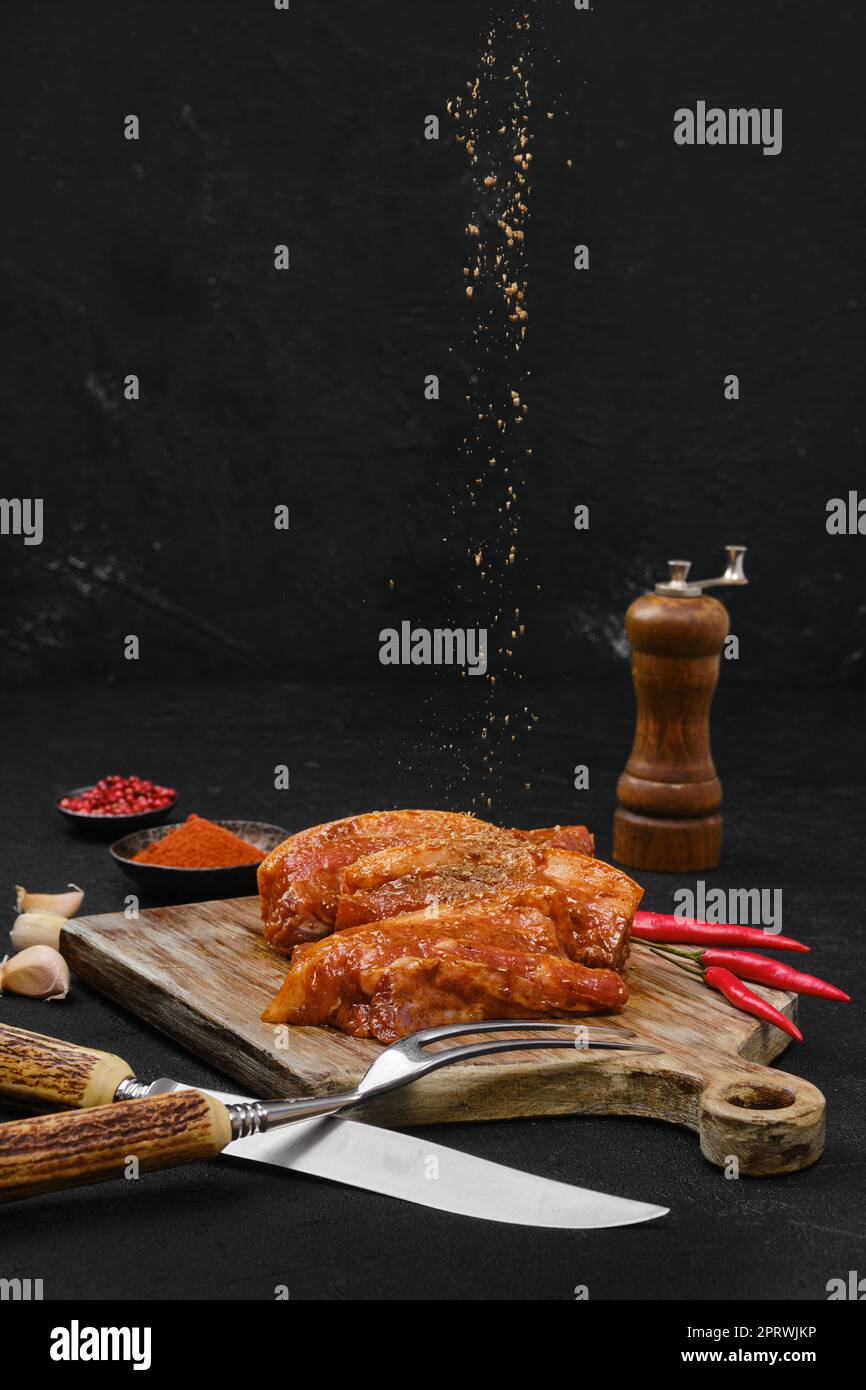 Pouring spice rub at marinated pork belly slice with spice Stock Photo ...