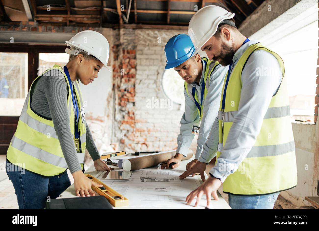 Architect, construction and teamwork with an engineer, designer and technician working together ...