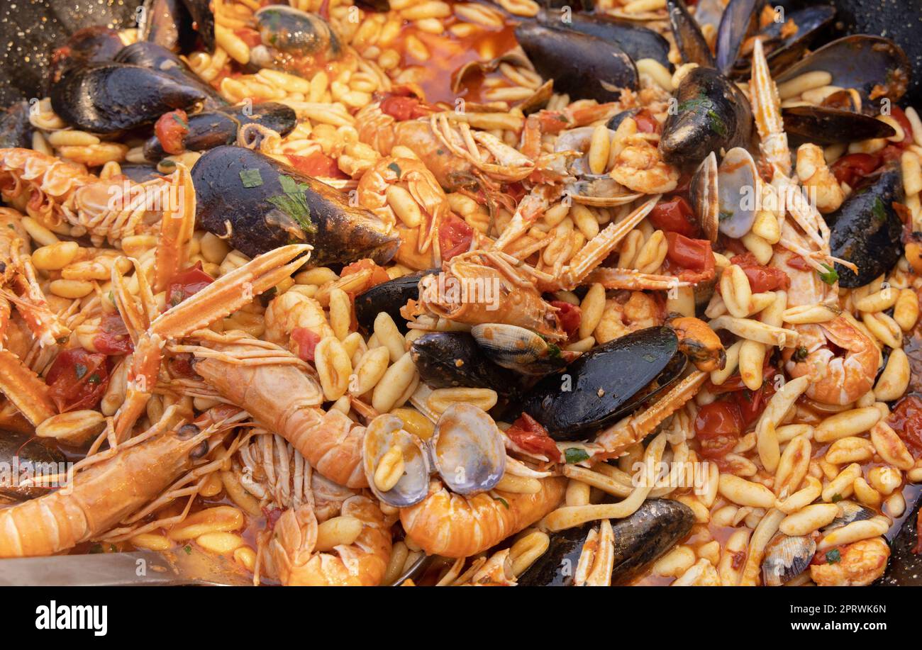 Italian Cavatelli allo scoglio, pasta with seafood and tomatoes close ...