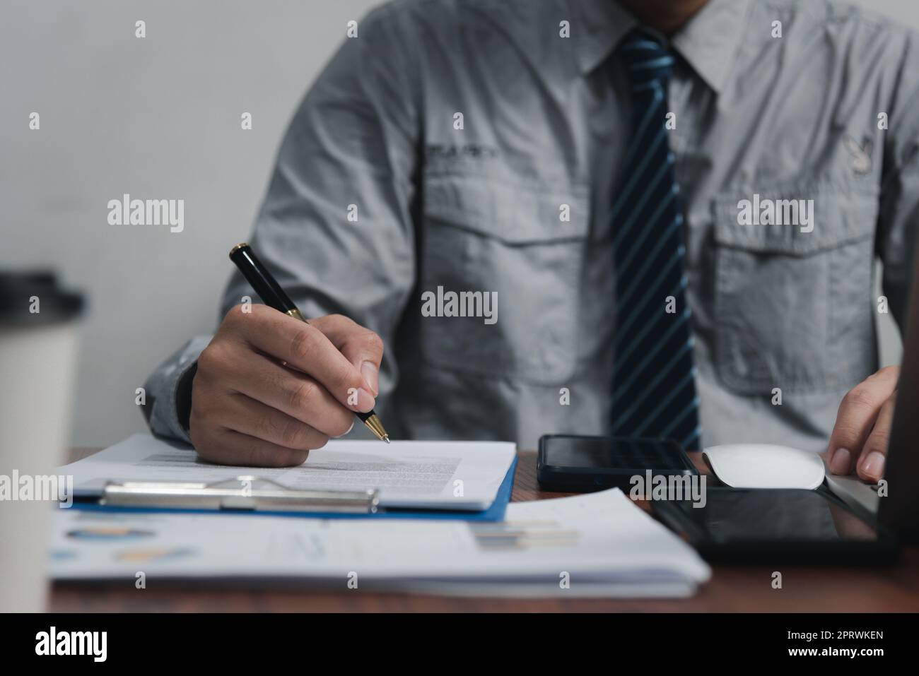 Businessman holding pen document graph accounting finance paper work ...