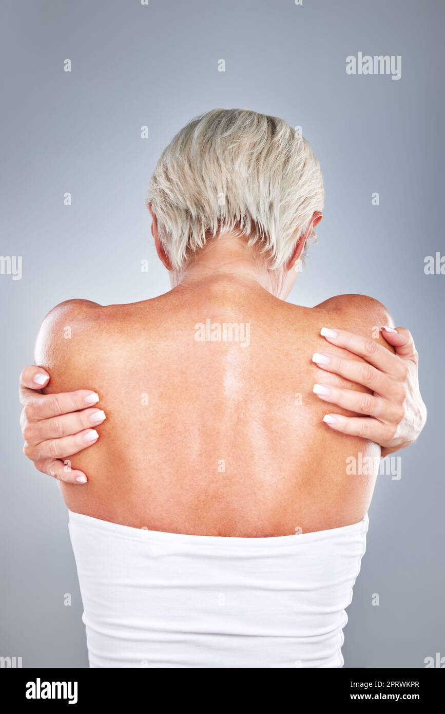 Skincare, back and senior woman with a hug for self love, beauty and ...