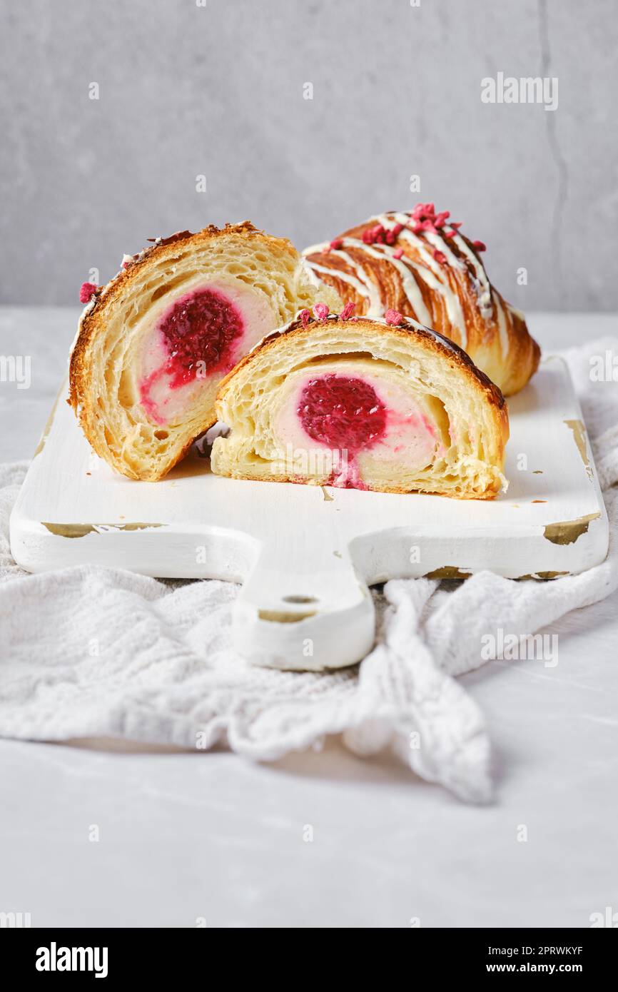 Croissant cut in half, showing the cross section with raspberry ...