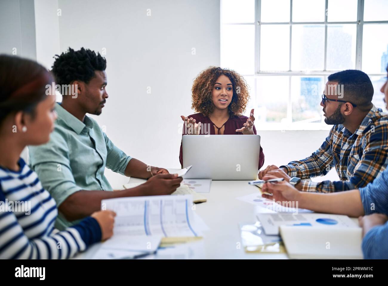 Growing their brand through teamwork. a team of designers brainstorming ...