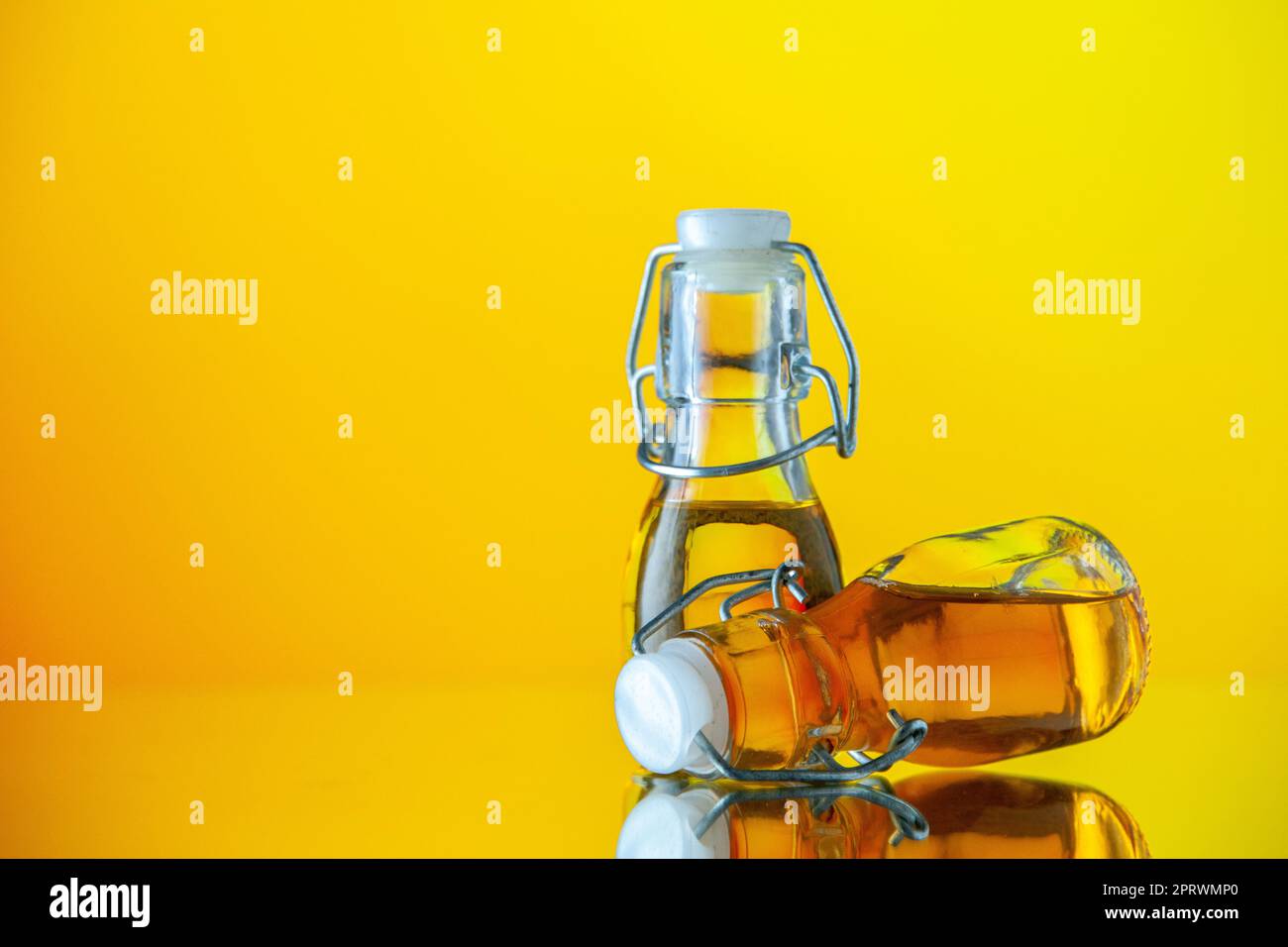 front view two oil bottles on yellow background free space Stock Photo ...