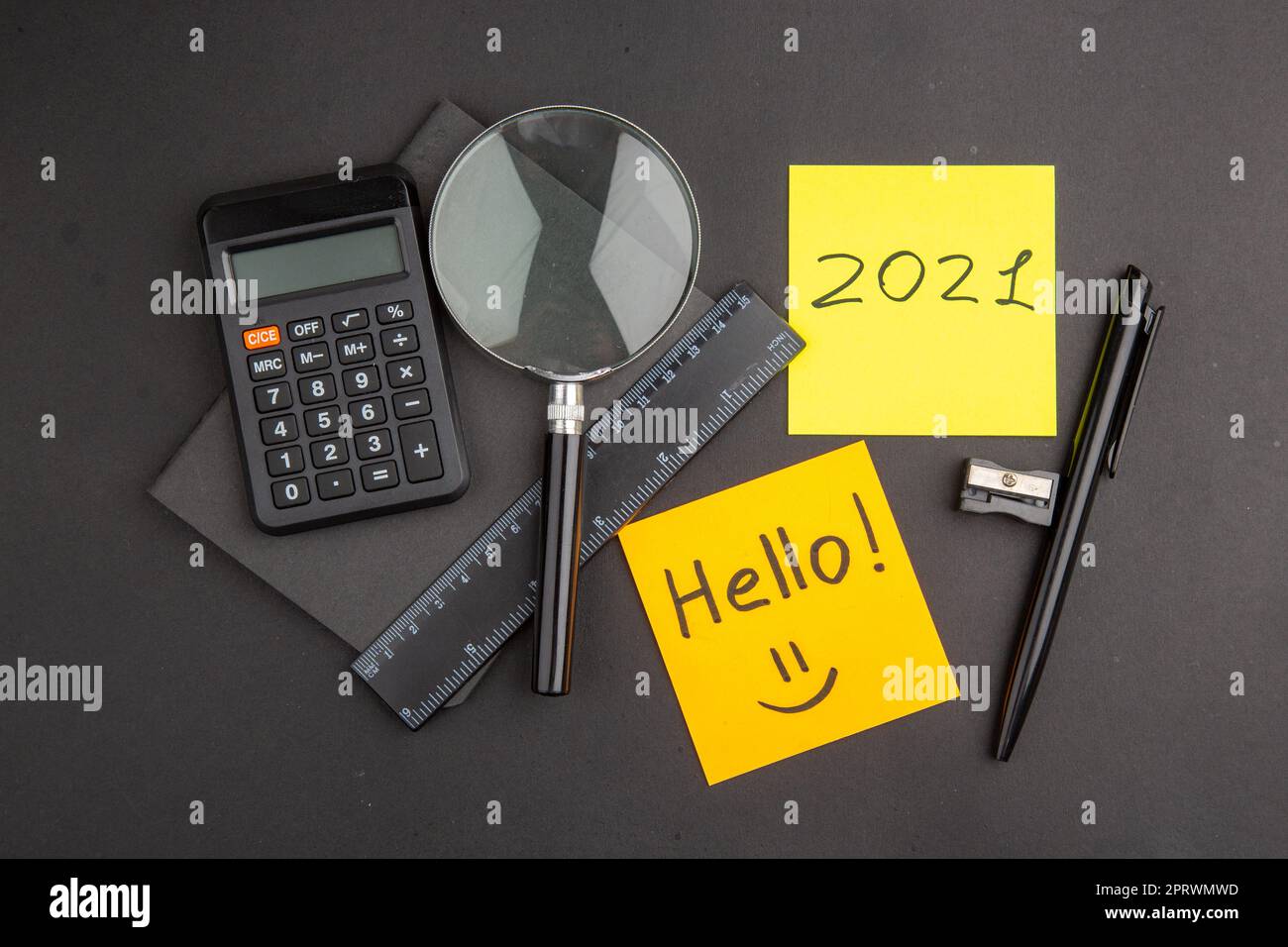 top view hello and written on sticky notes pen ruler lupa calculator ...