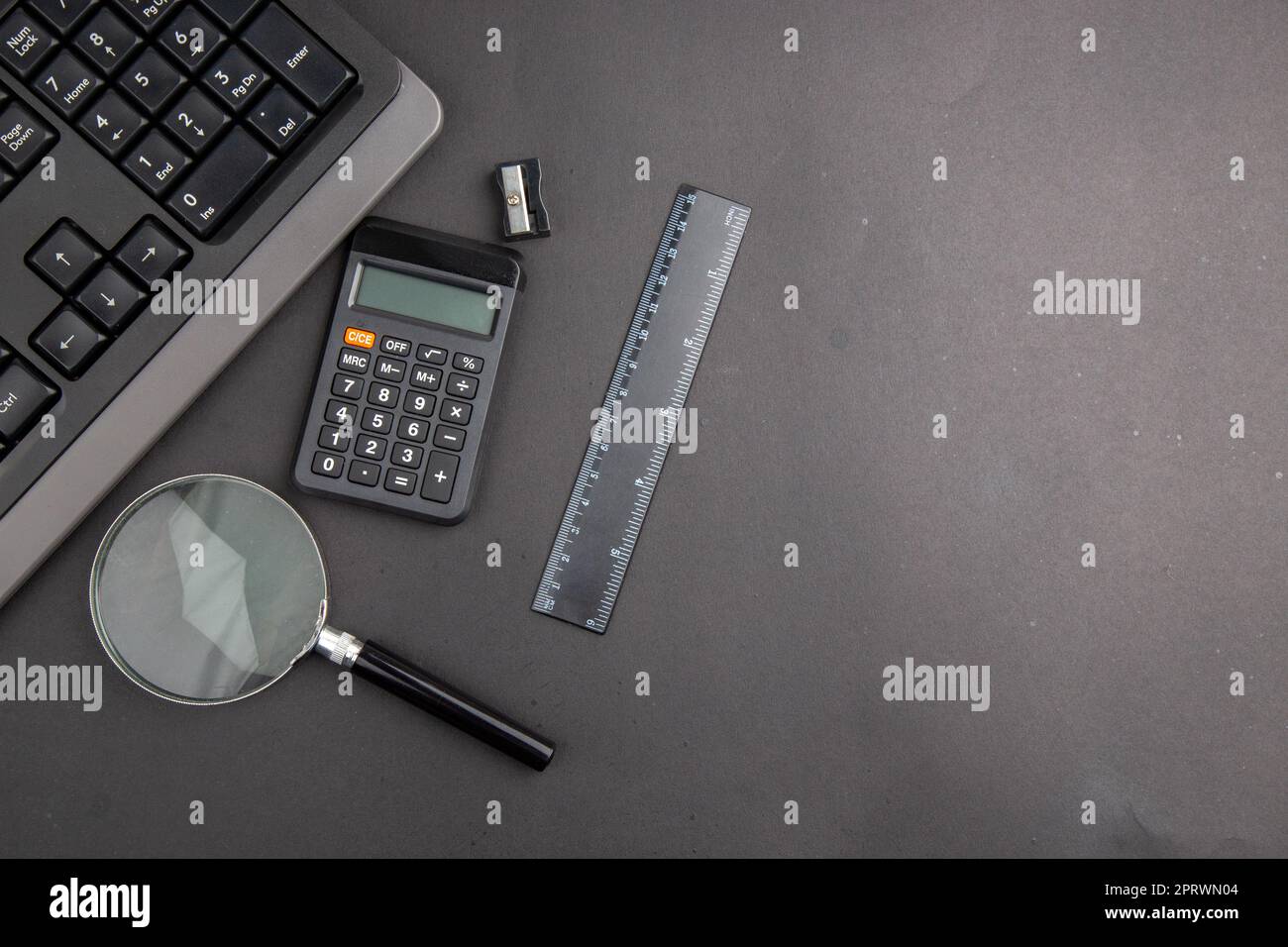 top view black office stuffs keyboard calculator lupa ruler pencil ...