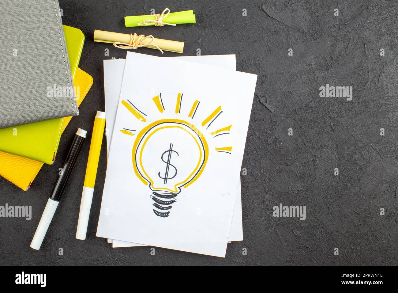 top view colorful notepads yellow and black markers idealight bulb on ...