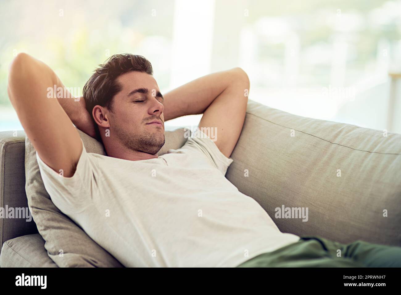 Time to release and relax. a young man relaxing on the sofa at home ...