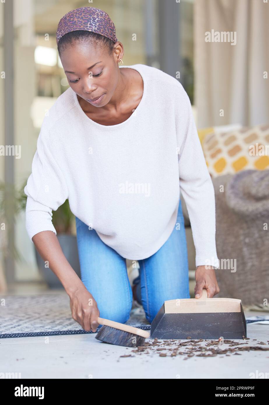 Dust, woman and cleaning on a floor, sweeping and scoop in a living ...