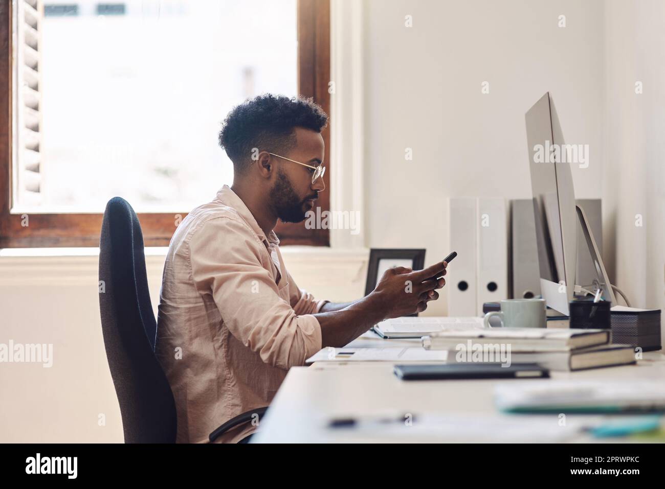 Business is about maintaining connections. a young businessman using a ...