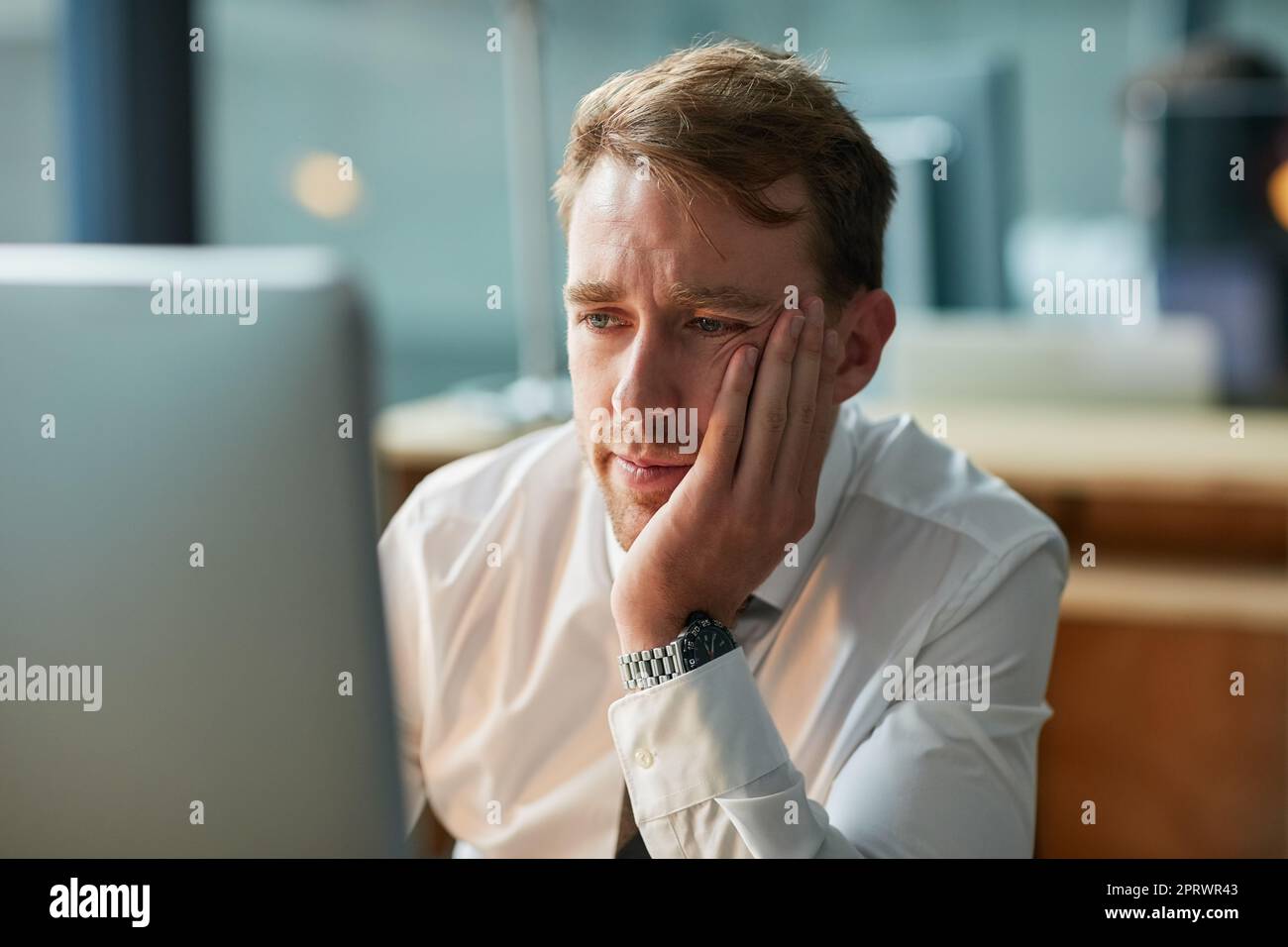 Why does this day feel so long. a bored businessman staring blankly at ...