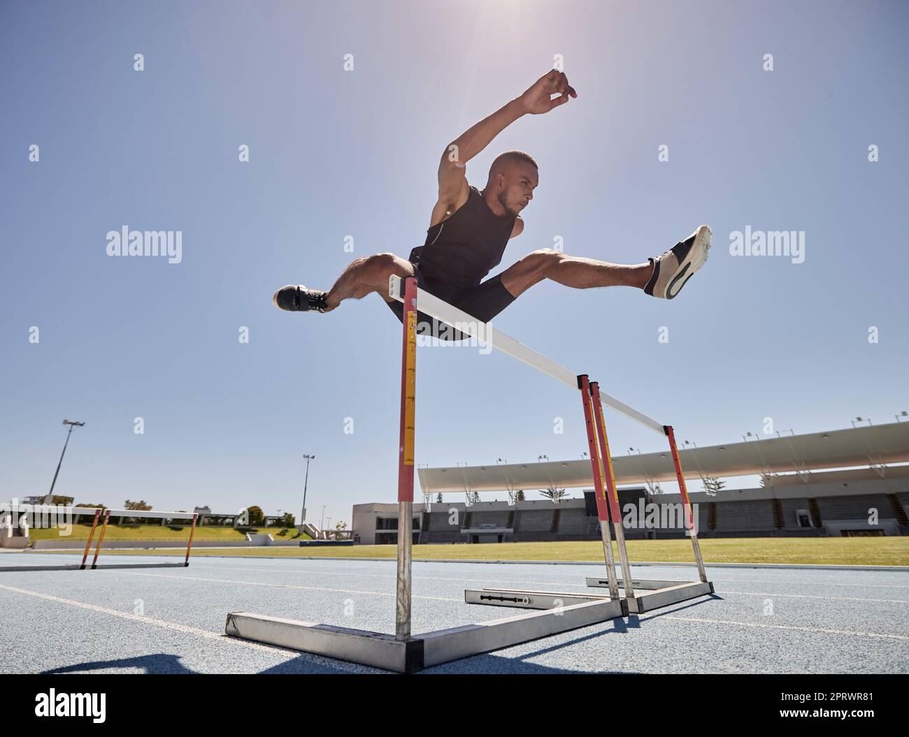 Man jumping hurdle hi-res stock photography and images - Alamy