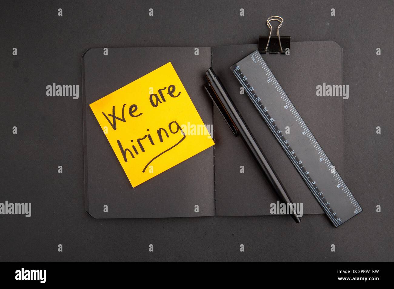 top view black notepad we are hiring written on note paper ruler pen ...