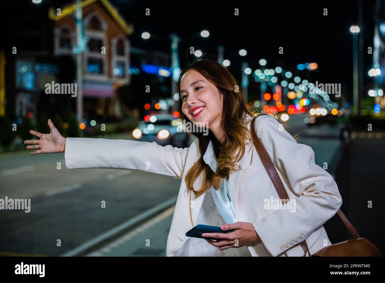 businesswoman standing hail waving hand taxi on road in busy city ...