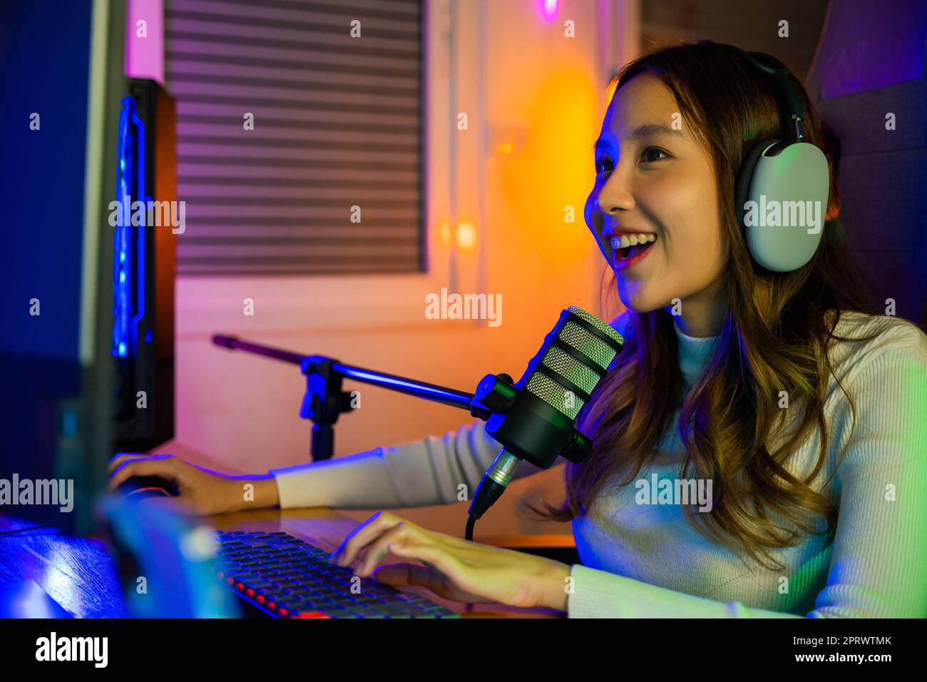 woman wear headphones playing video games online on computer she live ...