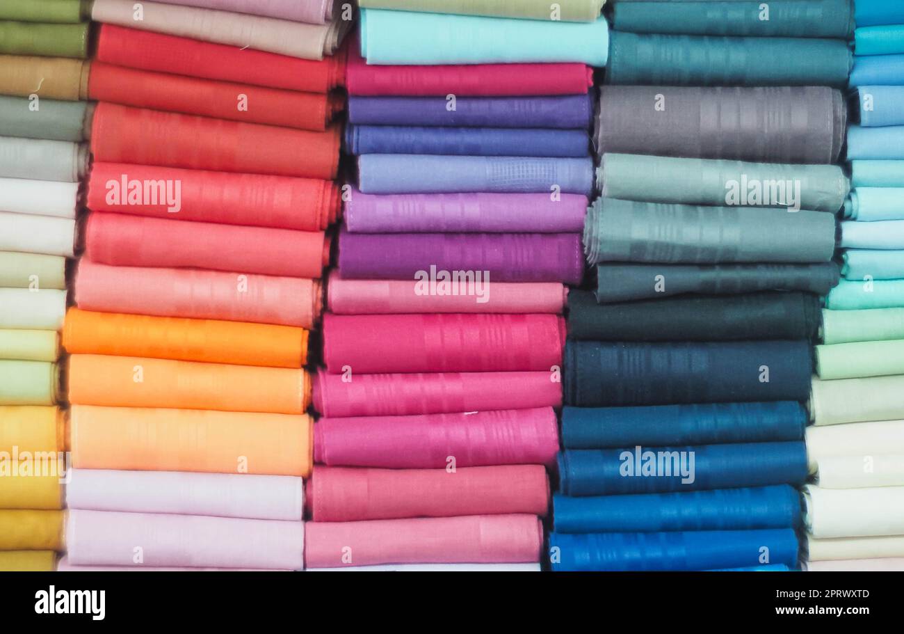 colorful fabric rolls in textile shop industry.Rolls of bright colored ...