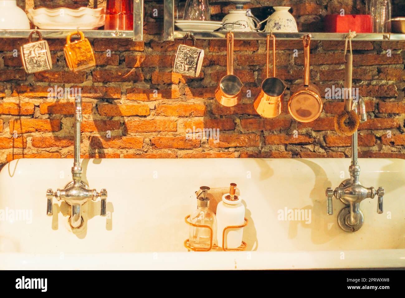 Vintage kitchen utensils on the wall above the sink. retro kitchenware ...