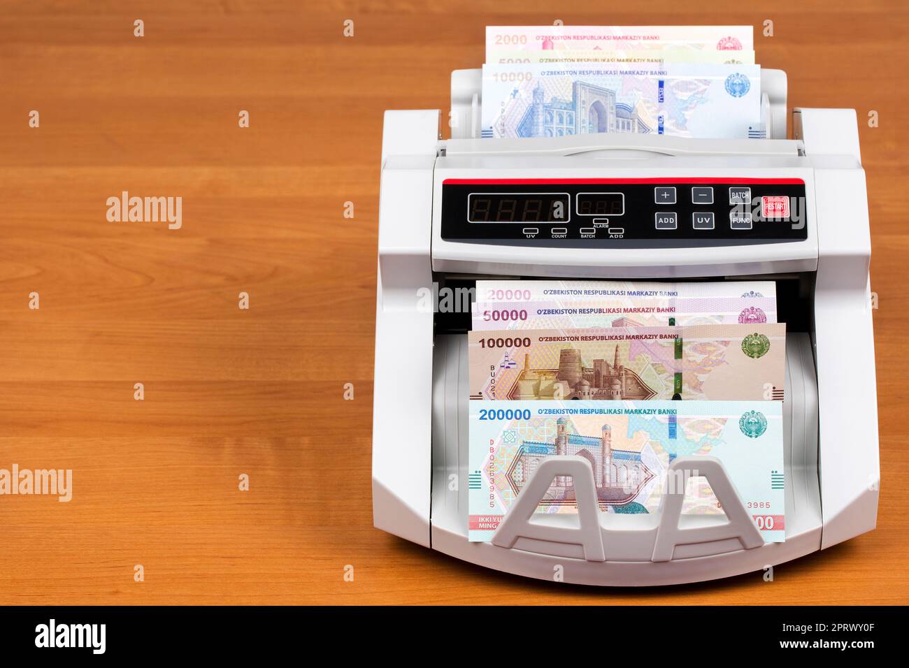 Uzbekistani money in the counting machine Stock Photo - Alamy