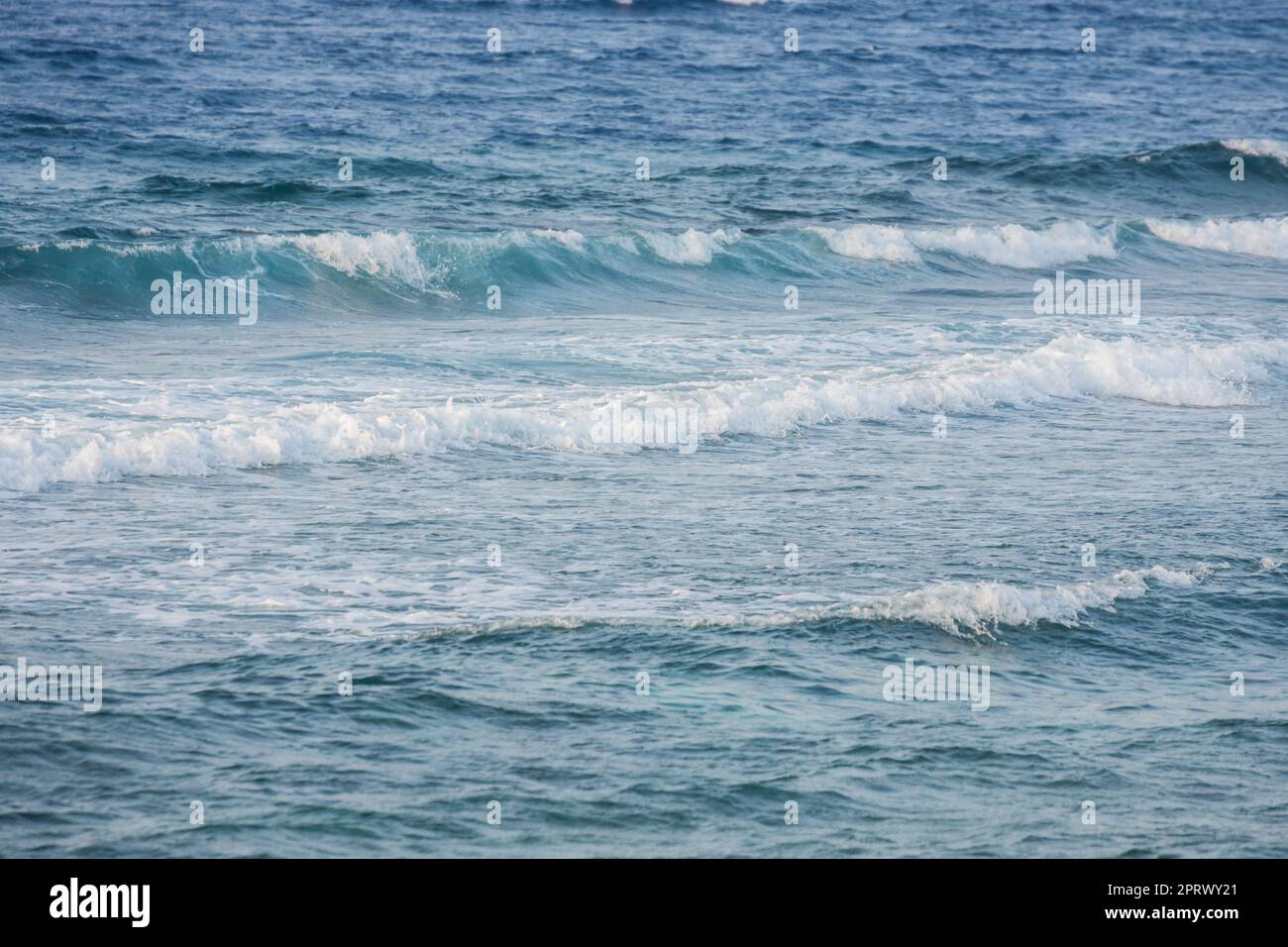high waves at a beach with blue seawater Stock Photo - Alamy