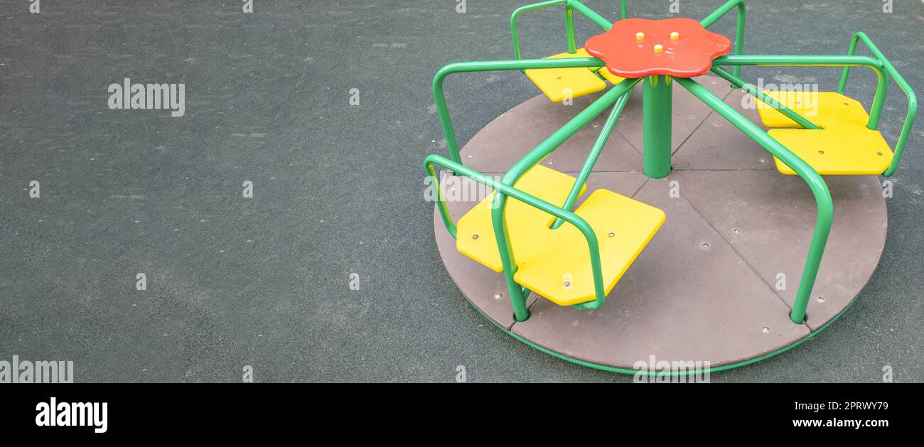Multi-colored steel round carousel on the playground, a copy of the ...