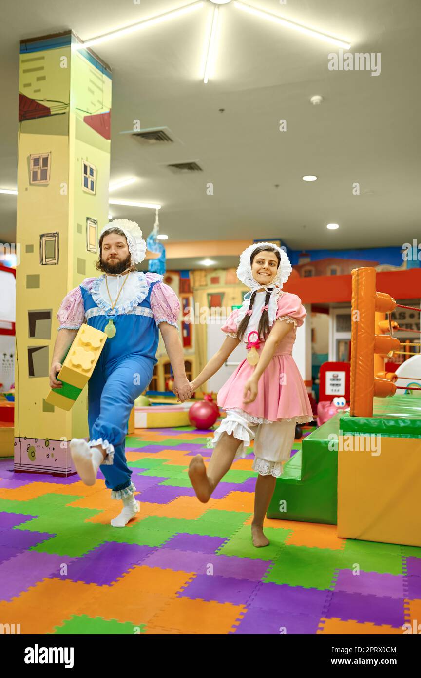 Man and woman like babies holding hands walking together Stock Photo ...