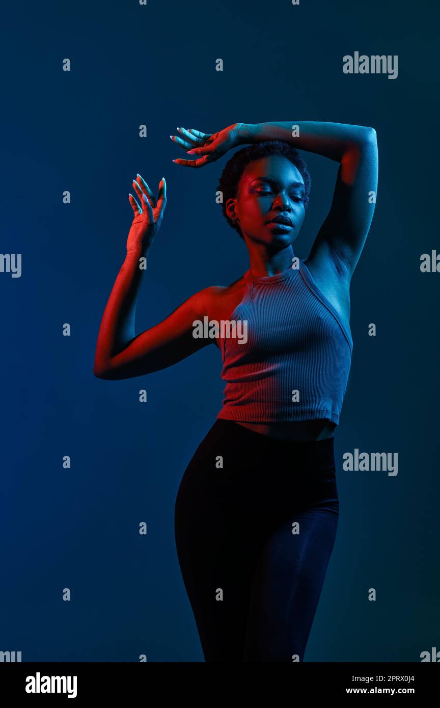 Woman moving gracefully over dark studio background Stock Photo - Alamy