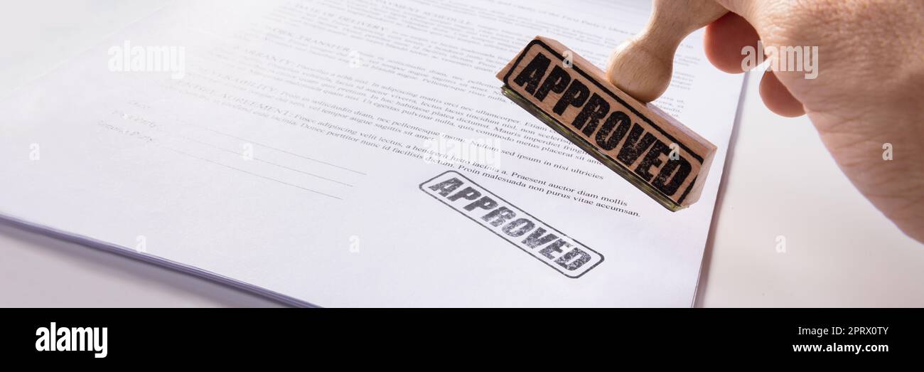 Person's Hand Stamping Approved On Contract Paper Stock Photo - Alamy