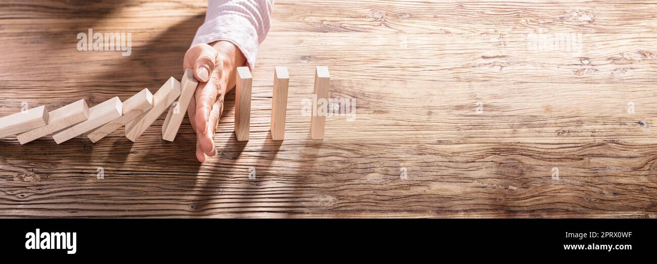 Domino Fall Prevention. Hand Stopping Blocks Stock Photo - Alamy
