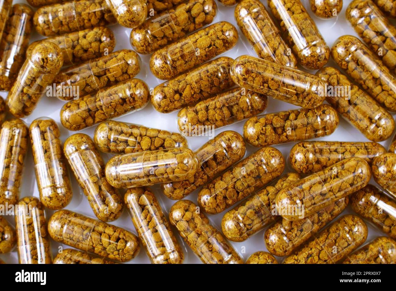 Top view of nutritional supplement capsules with bee pollen inside ...