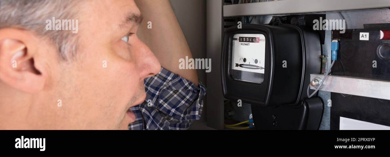 Shocked Man Looking At Meter Stock Photo - Alamy
