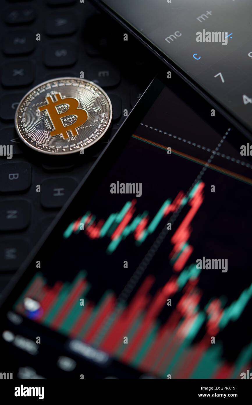 Bitcoin cryptocurrency with candle stick graph chart, laptop keyboard, and digital background ...