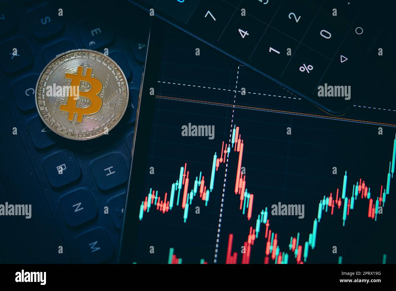 Bitcoin cryptocurrency with candle stick graph chart, laptop keyboard, and digital background ...