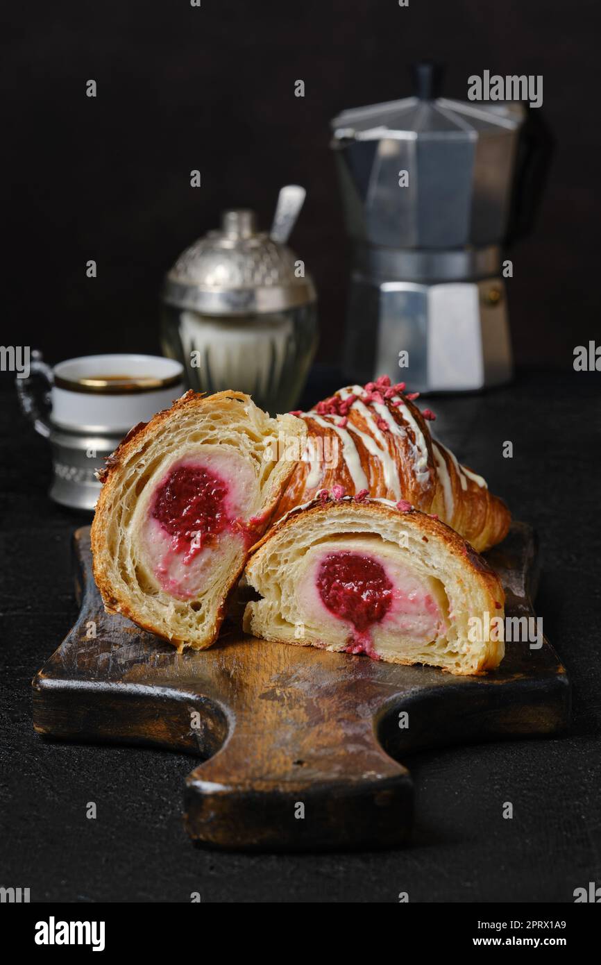 Fresh croissant cut on half showing raspberry filling Stock Photo - Alamy