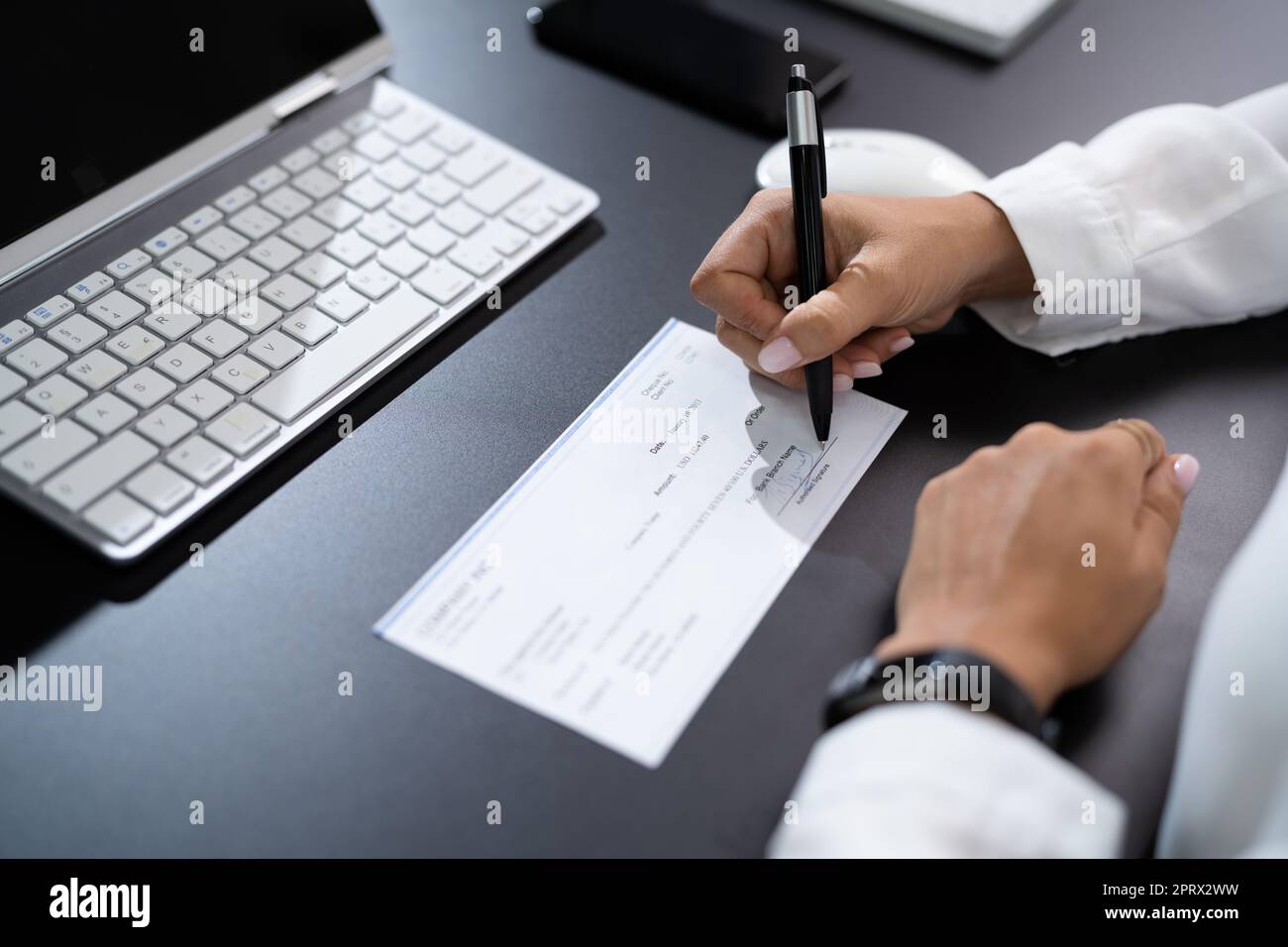 Signing cheques hi-res stock photography and images - Alamy